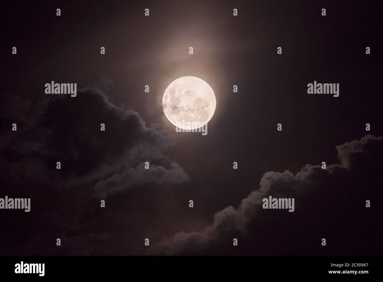 cloudy night with a full super moon Stock Photo - Alamy