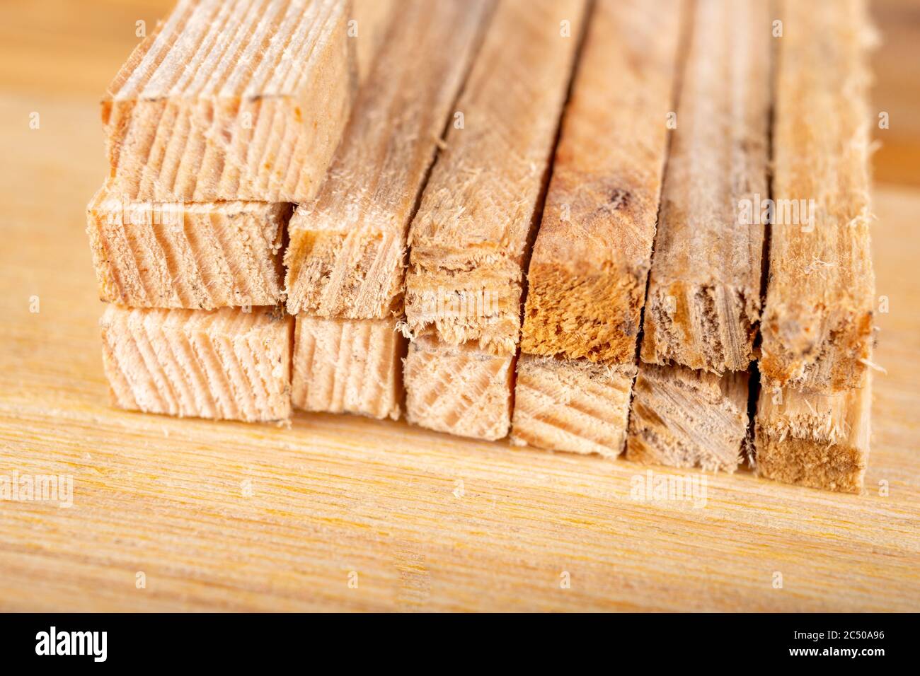Wooden raw slats stacked. Pieces of wood used to build furniture. Light ...