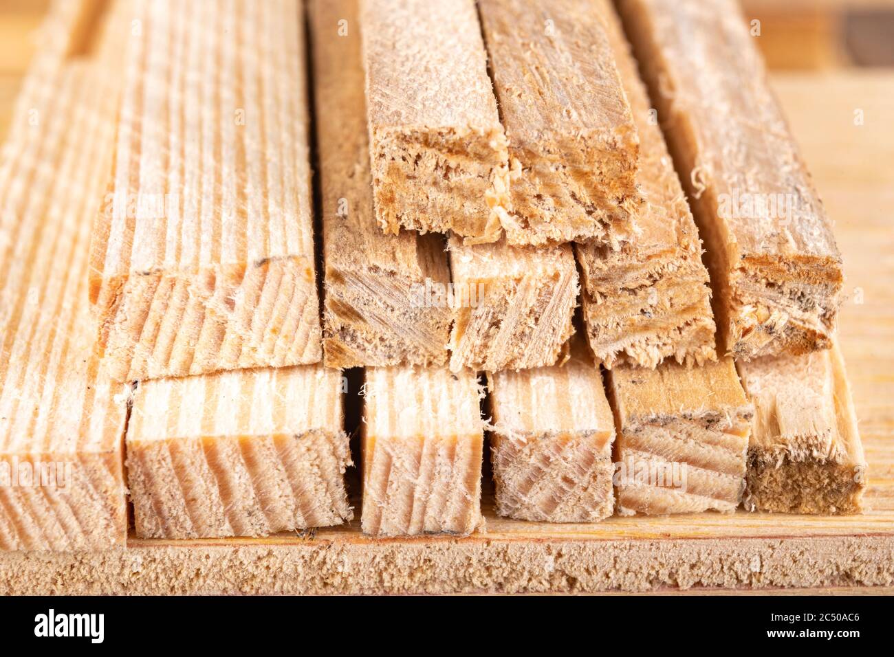 Wooden raw slats stacked. Pieces of wood used to build furniture. Light ...