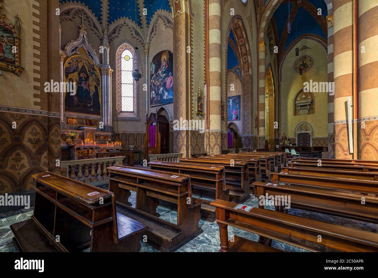 Wooden pews along altars and columns inside of San Lorenzo - a Roman ...