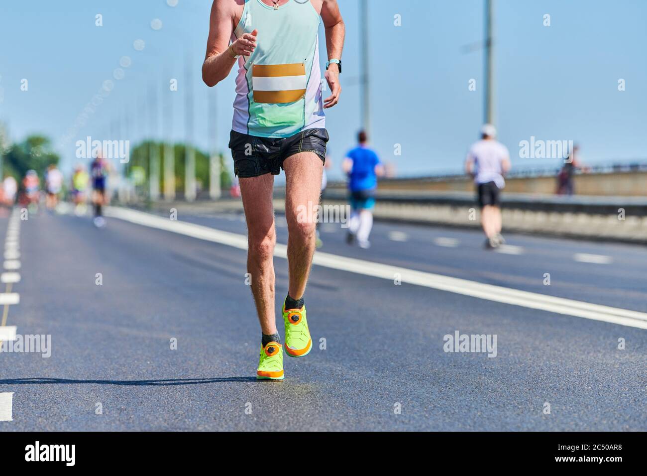Running man. Athletic man jogging in sportswear on city road. Healthy lifestyle, fitness sport ...