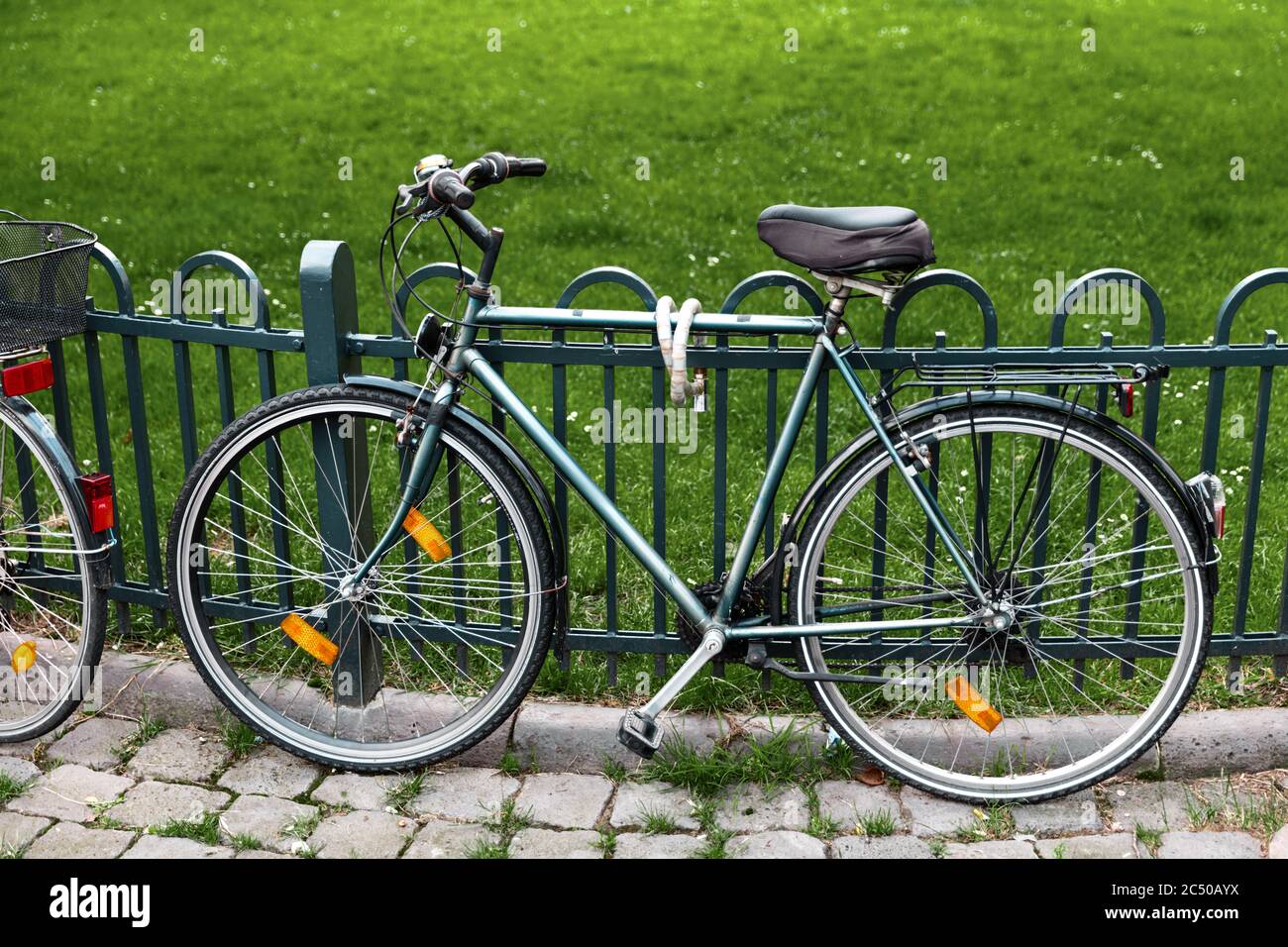 bike at the fence. urban transport. bike is securely locked to the ...