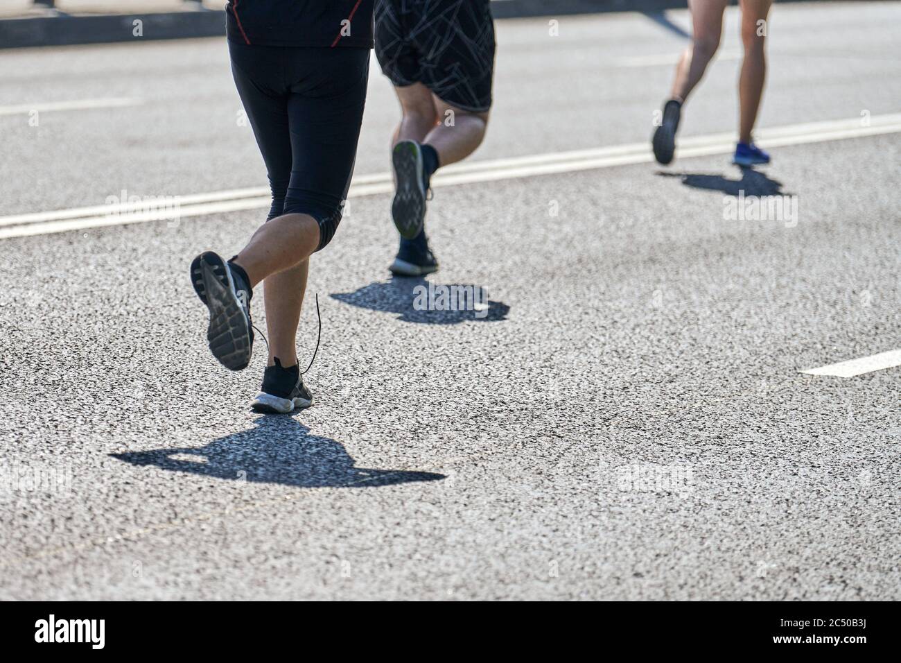 Marathon runners on city road. Running competition. Street sprinting ...