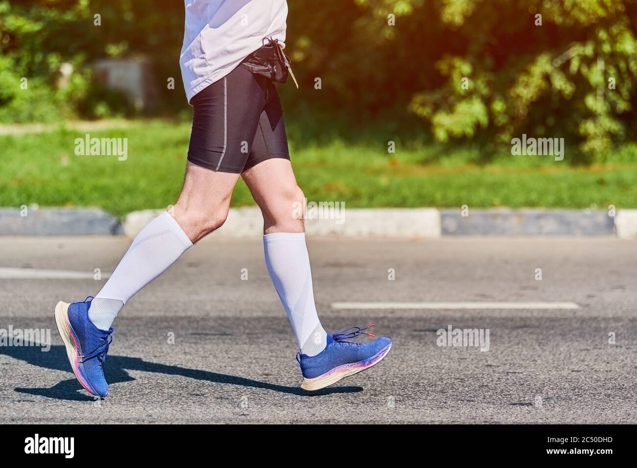 Running man. Athletic man jogging in sportswear on city road. Healthy ...