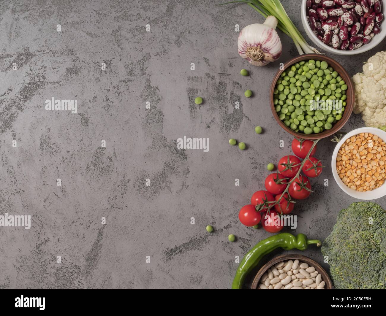 Organic vegetables and assorted beans on a grey background Stock Photo ...