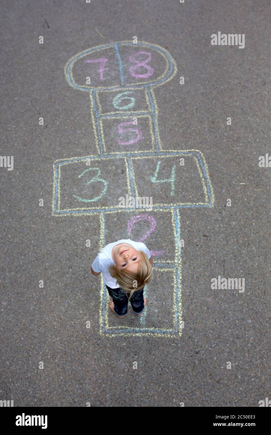 Boy playing hopscotch outside on hi-res stock photography and images ...