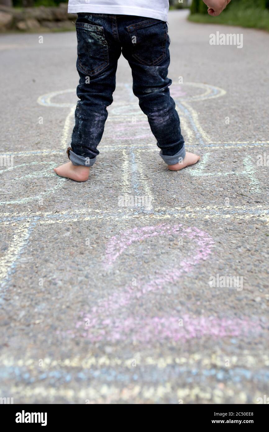 Boy Playing Hopscotch Outside On High Resolution Stock Photography and ...