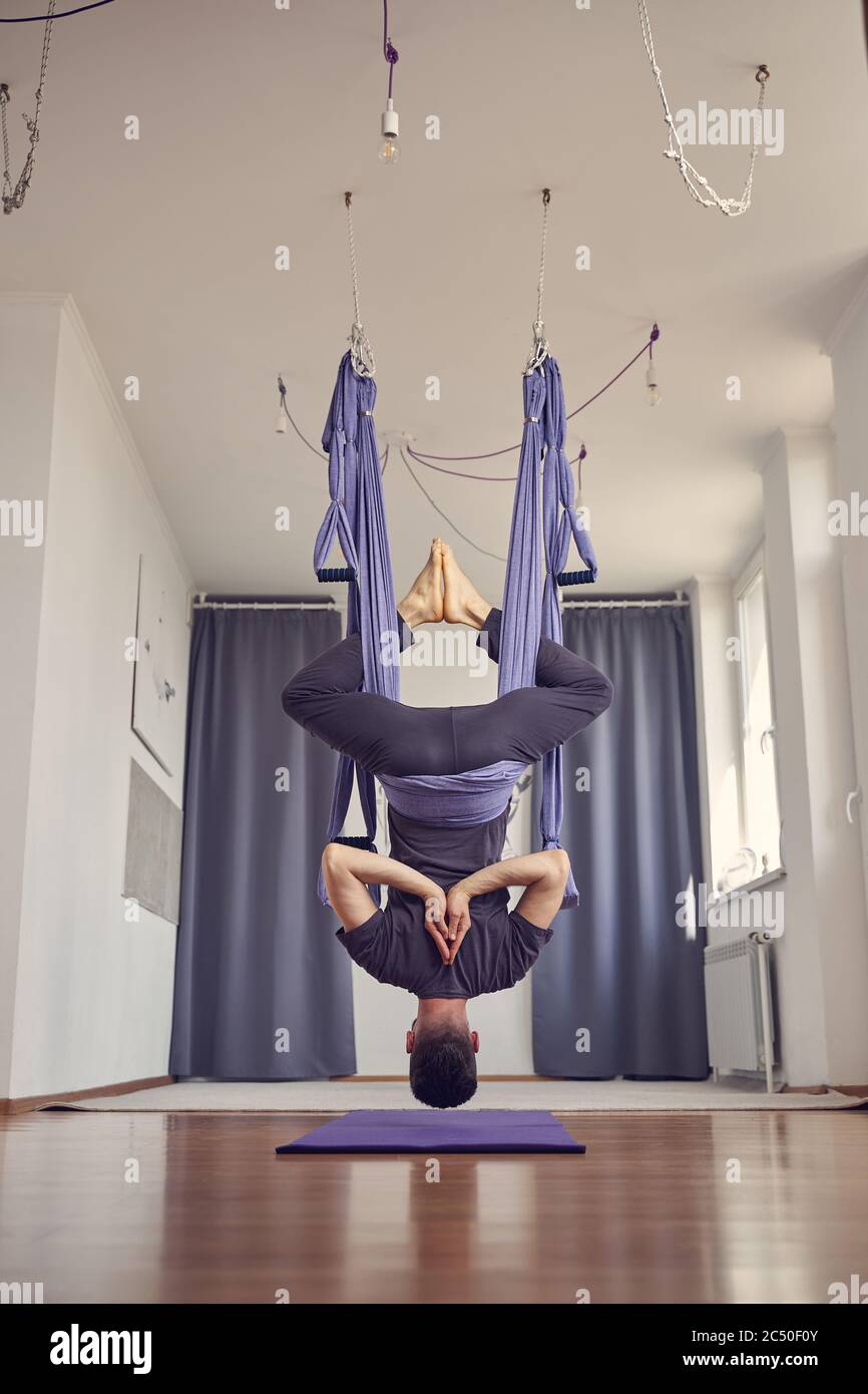 Man hanging upside down hi-res stock photography and images - Alamy