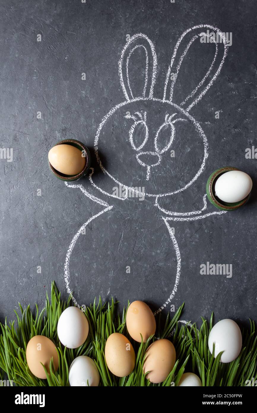 Easter bunny with eggs. Green grass and eggs. Chalk drawn bunny with ...