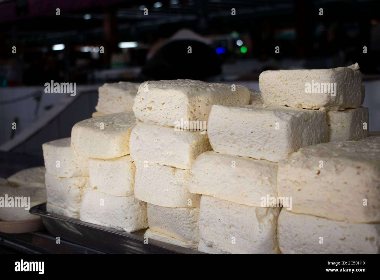 Blocks of cheese are stacked at a local market, ready for sale Stock ...