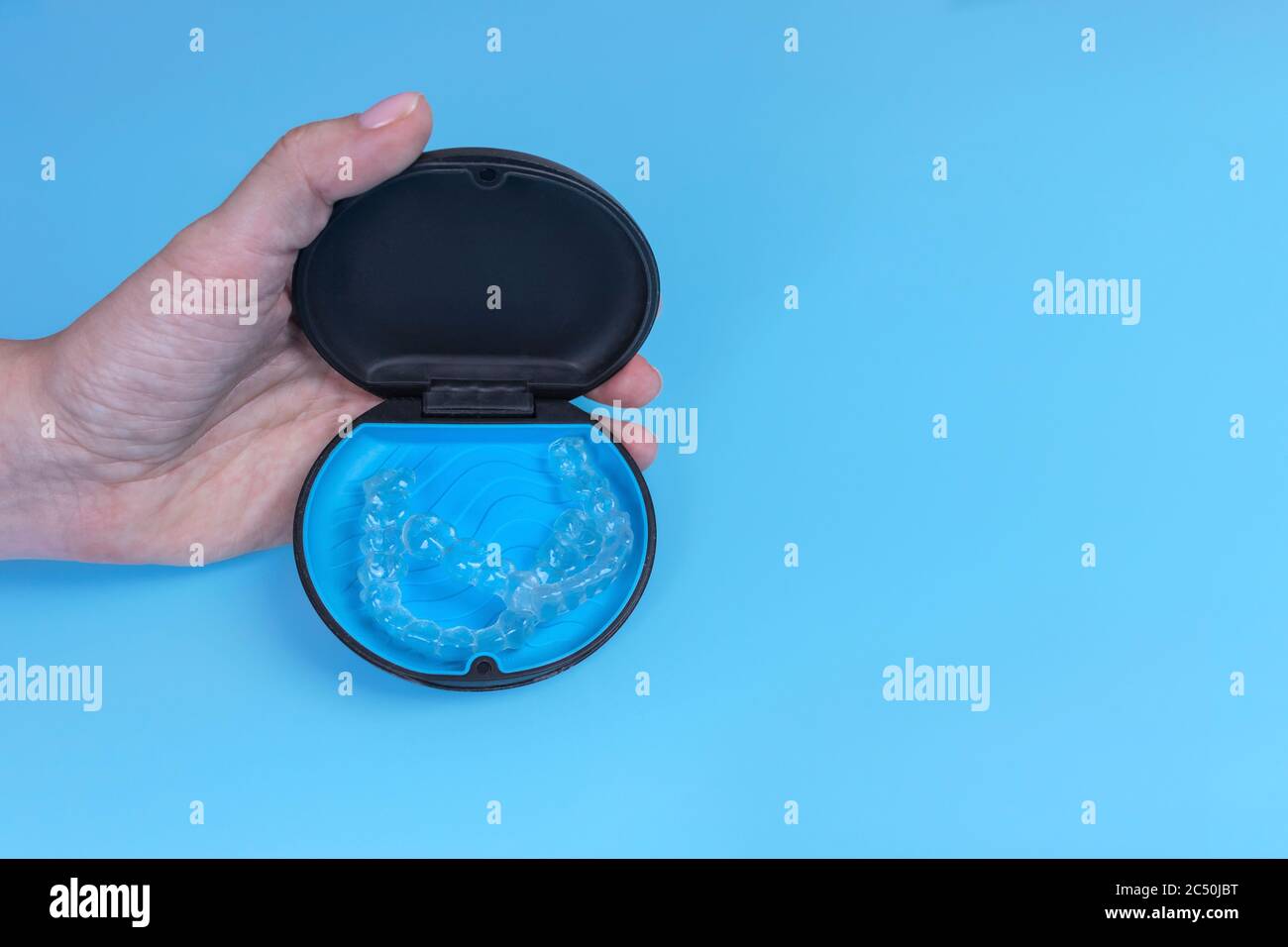 Invisible transparent aligners invisalign in container blue background ...
