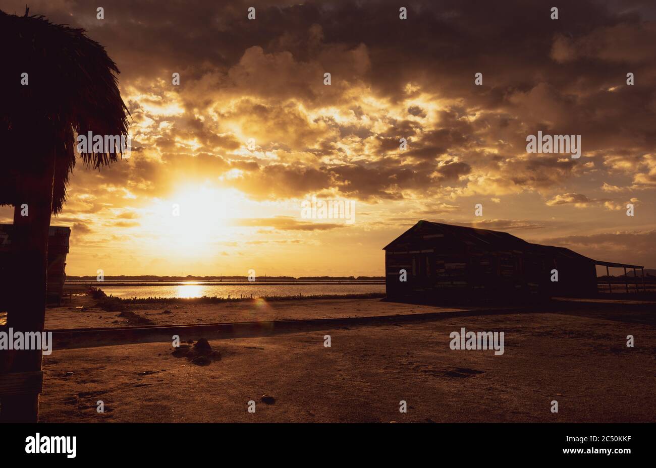 Old house on the beach at sunset Stock Photo - Alamy
