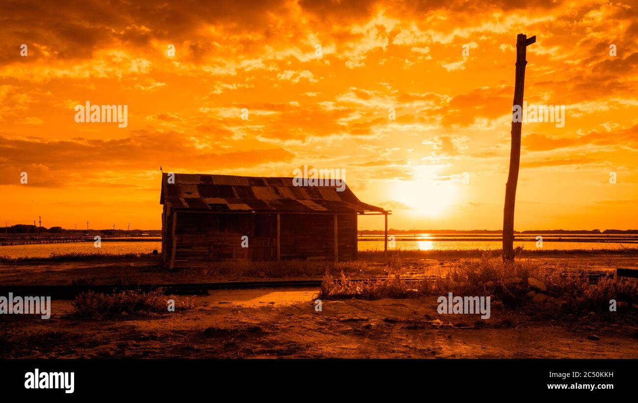 Old house on the beach at sunset Stock Photo - Alamy