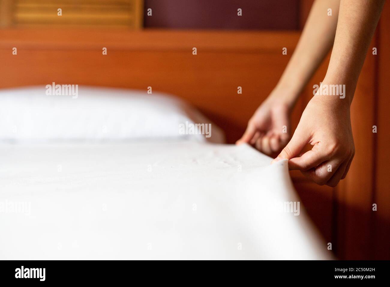 Woman making bed sheet hi-res stock photography and images - Alamy