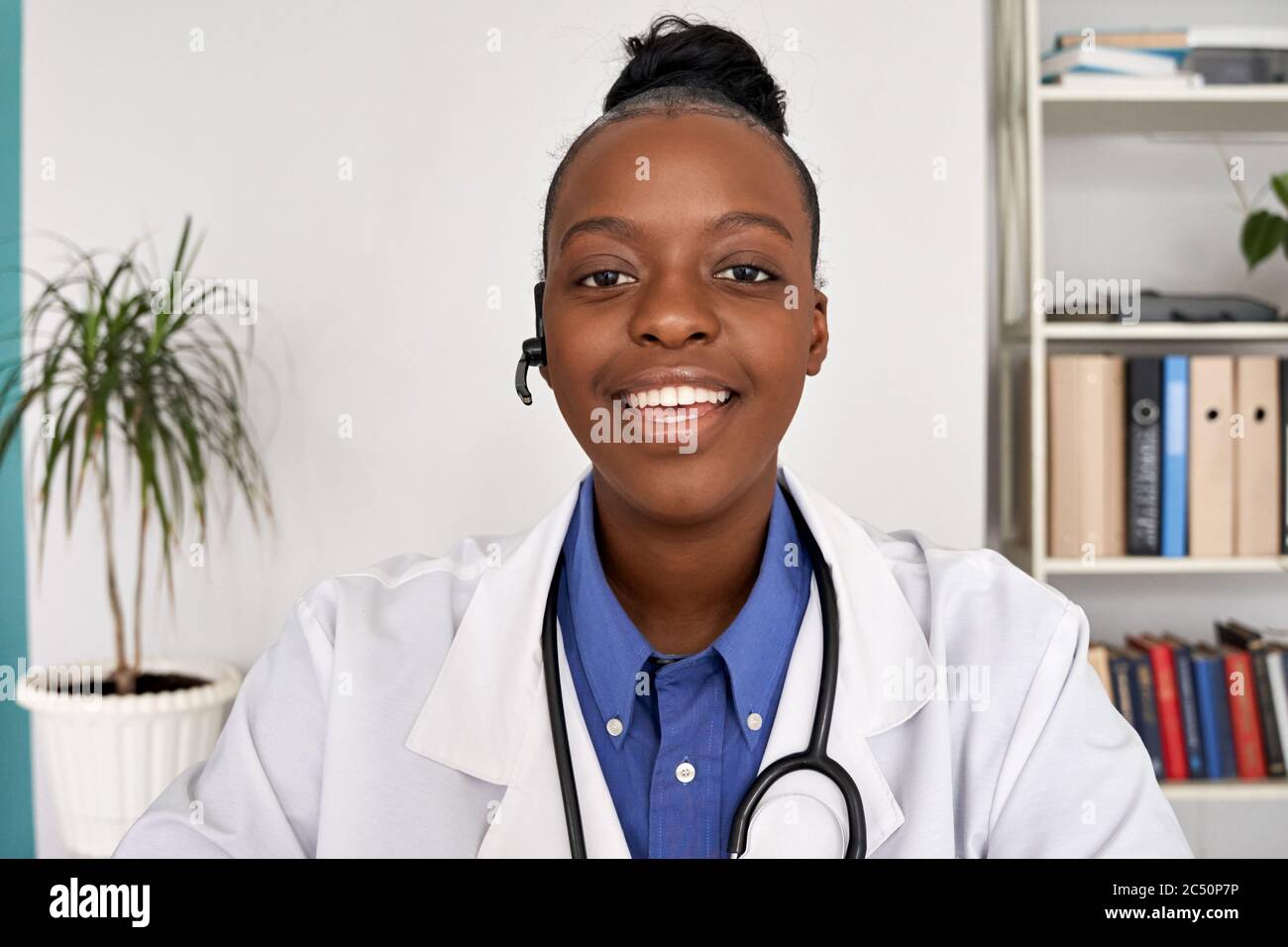 African female doctor wear headset make webcam zoom video call, face ...