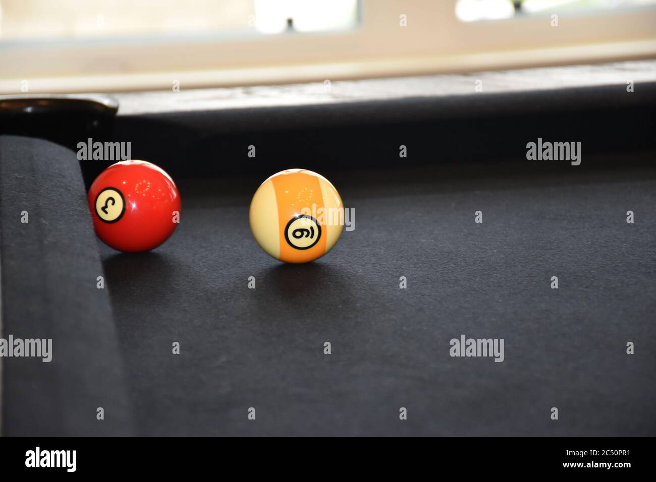 Black billiard table, Billiard balls in a pool table, focused on 9 ball ...