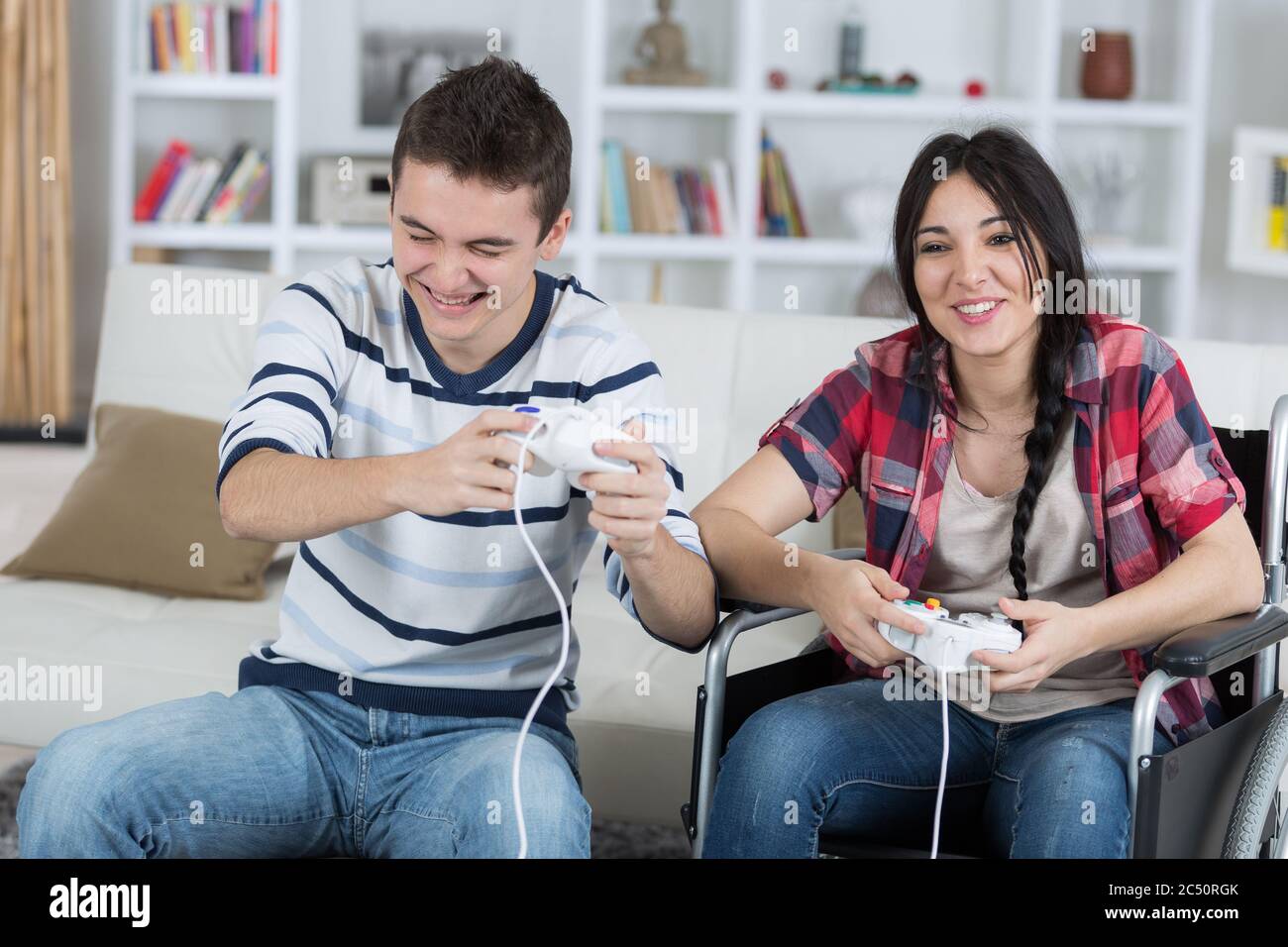 young people playing computer game female in wheelchair Stock Photo - Alamy