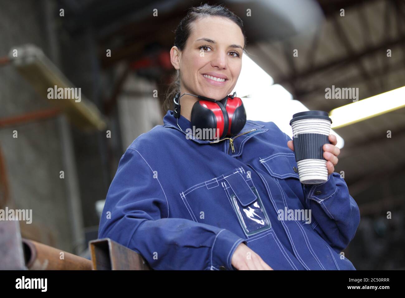 female smiling worker drinking coffee Stock Photo - Alamy