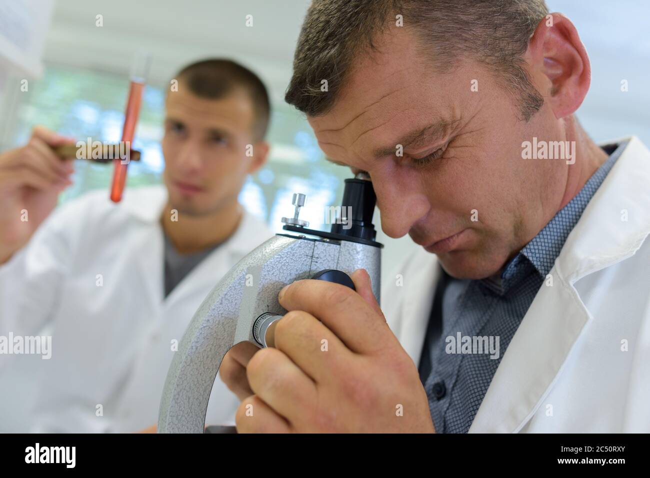a doctor man with microscope Stock Photo - Alamy