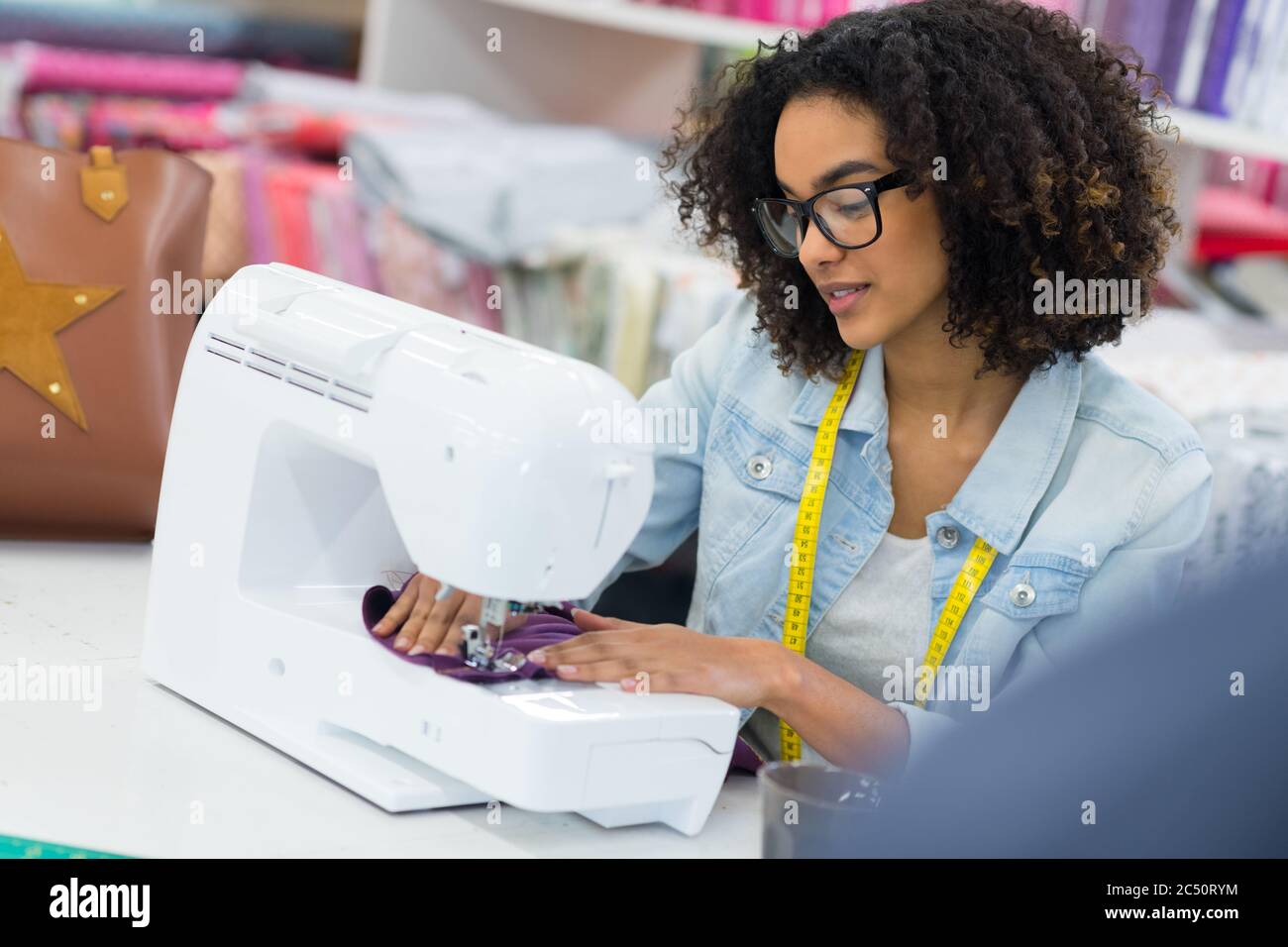 young woman sewing in a modern sewing machine Stock Photo - Alamy