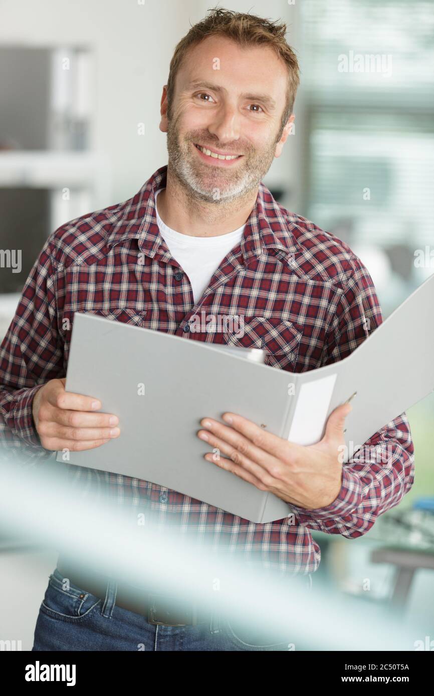 man holding folder at workplace workstation Stock Photo - Alamy