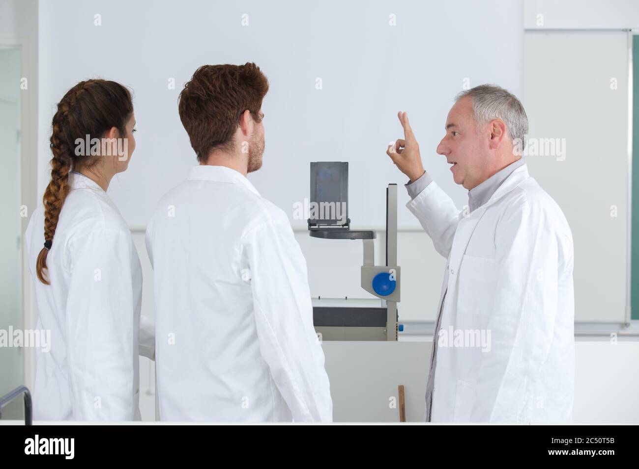 students listening carefully to their teacher during science class ...