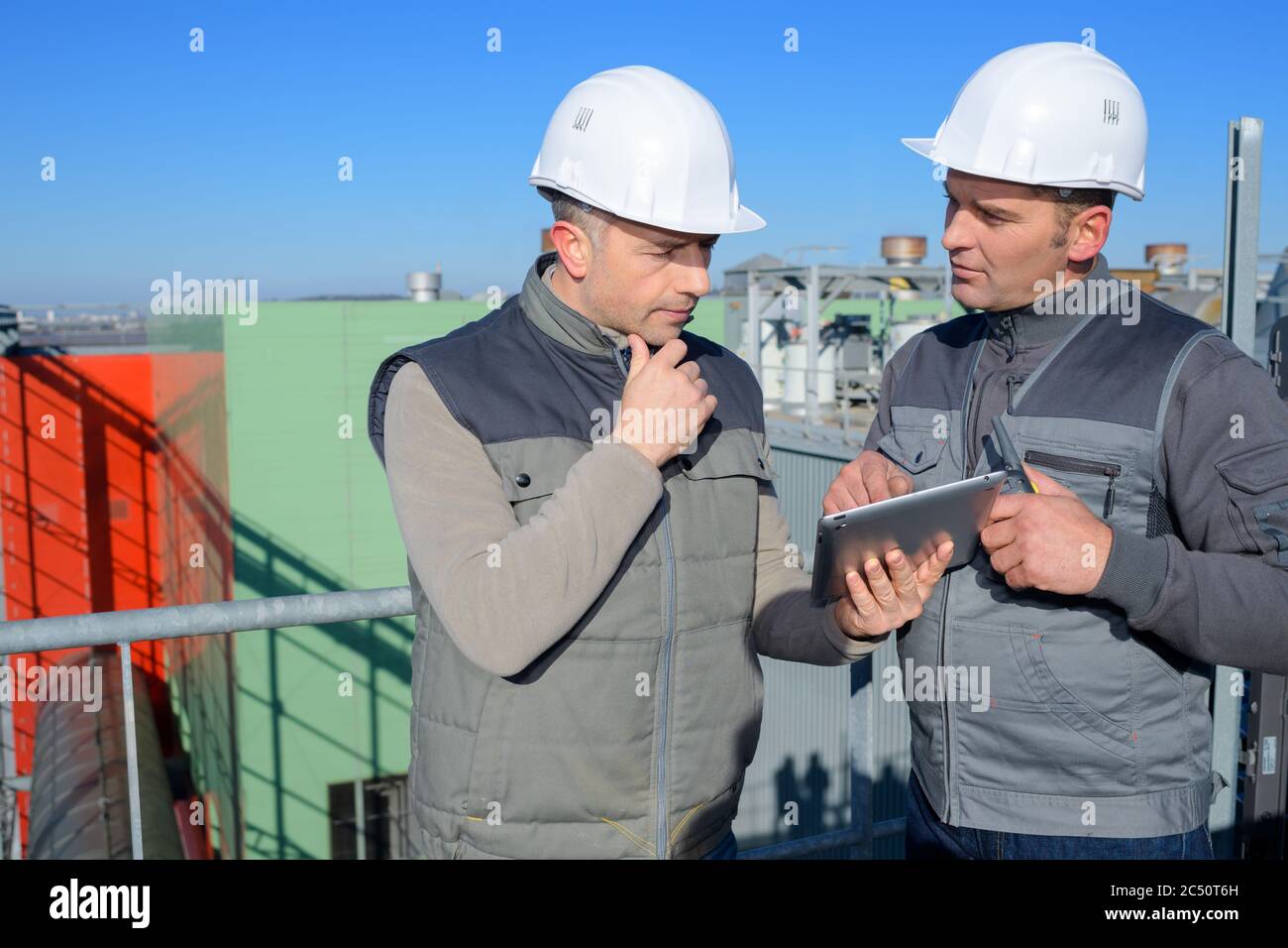 industrial factory workers having a conversation Stock Photo - Alamy