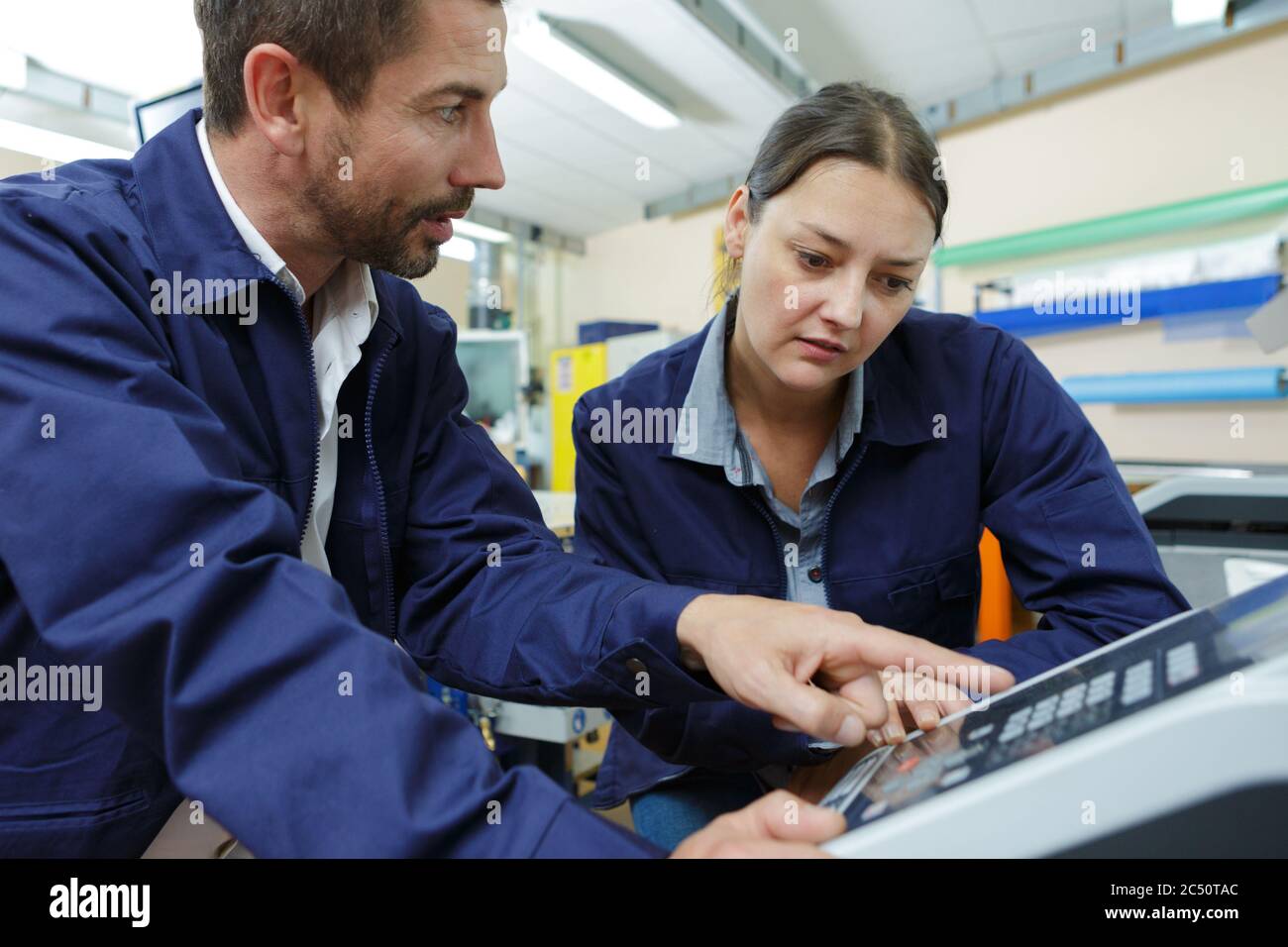 Woman operating a machine hi-res stock photography and images - Alamy