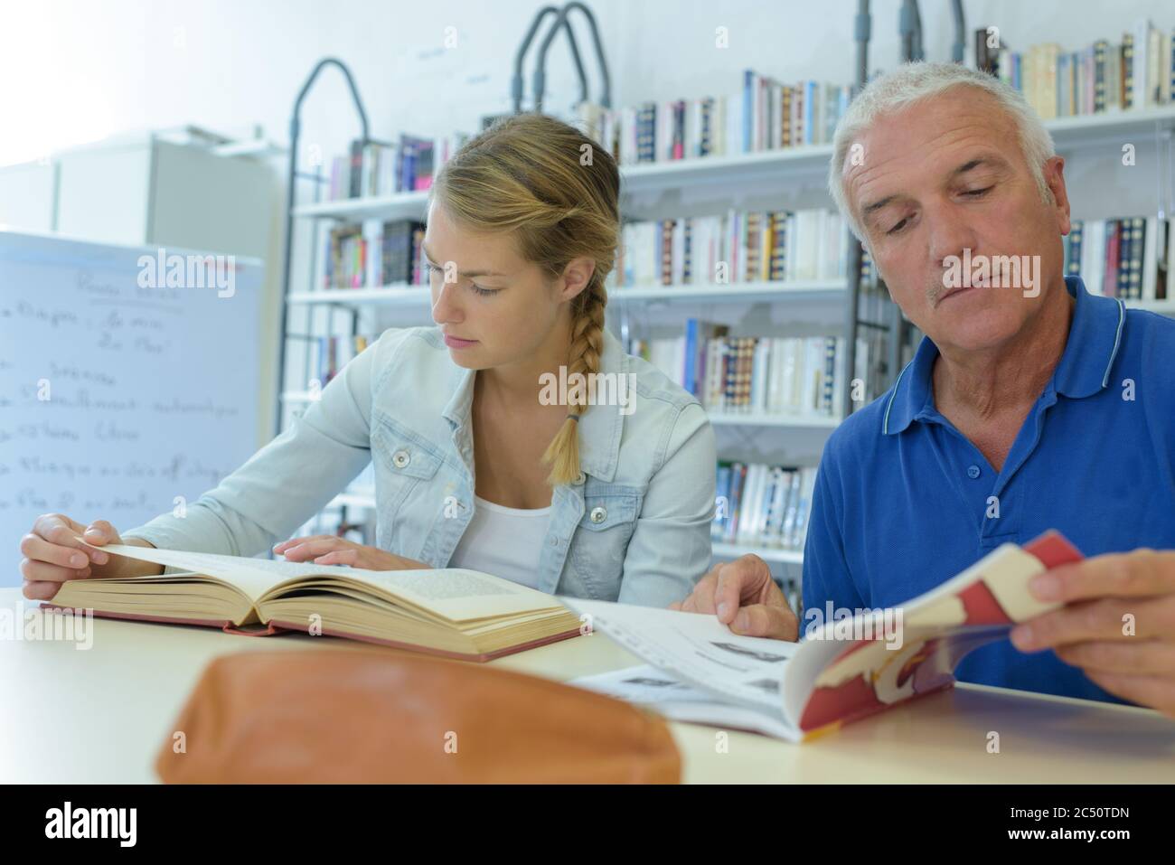 experienced teachers working in library Stock Photo - Alamy