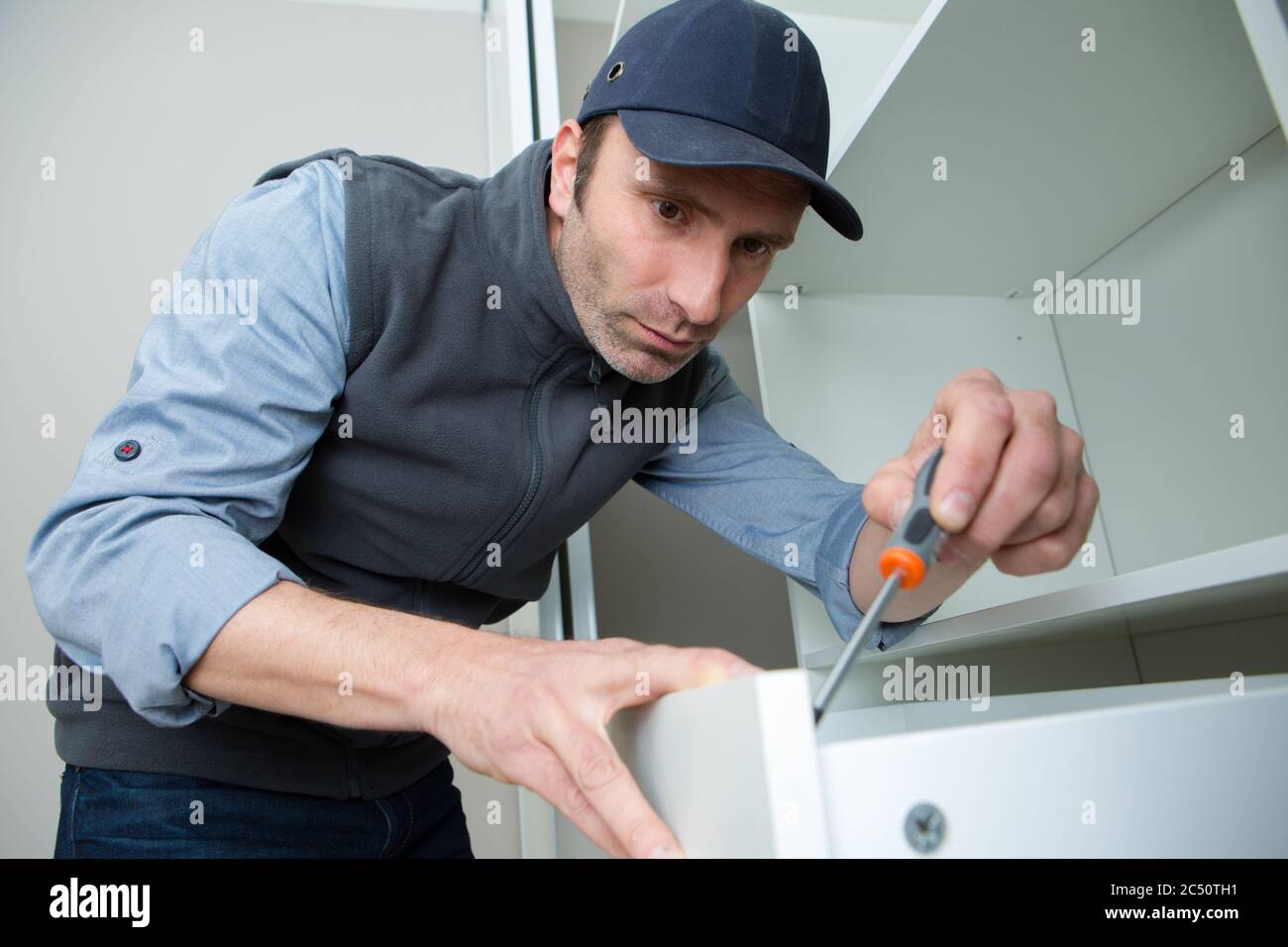 Process man using screwdriver hi-res stock photography and images - Alamy