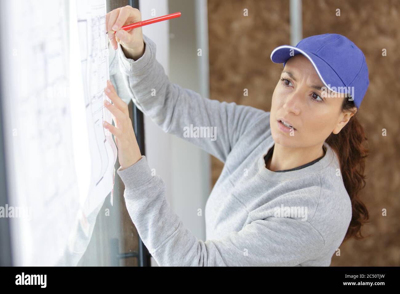 builder woman drawing over a building plan Stock Photo - Alamy