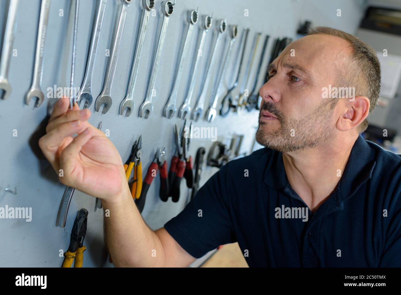 screwdriver mechanic takes a screwdriver from the workshop Stock Photo ...