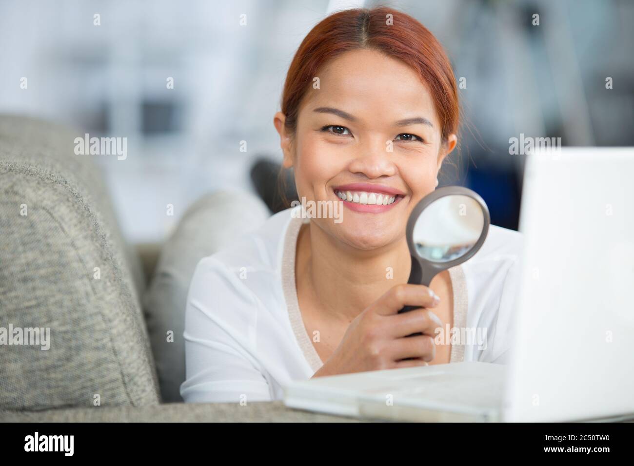 One woman magnifying glass laptop hi-res stock photography and images ...