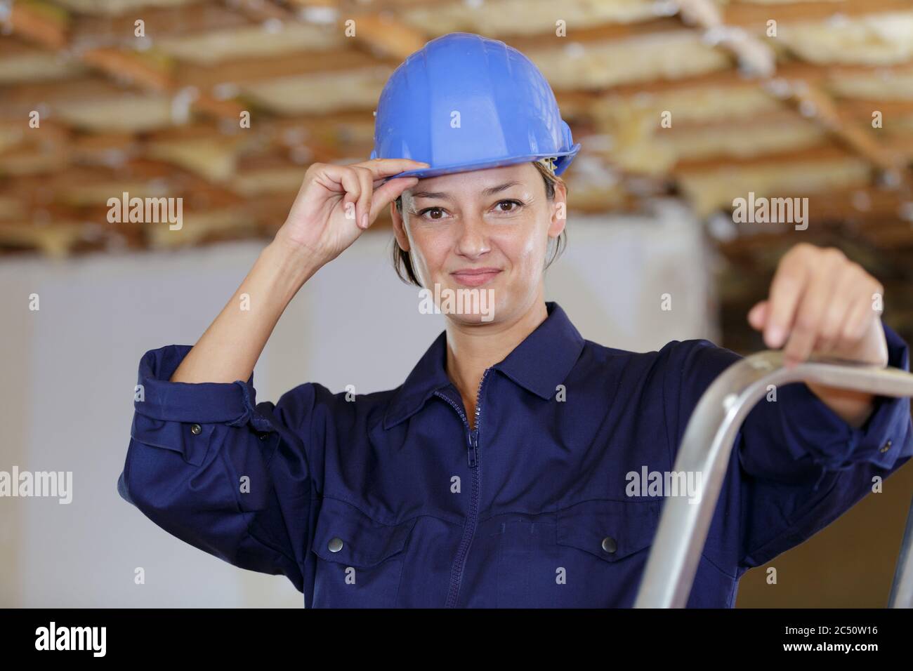 female builder looking at camera Stock Photo - Alamy