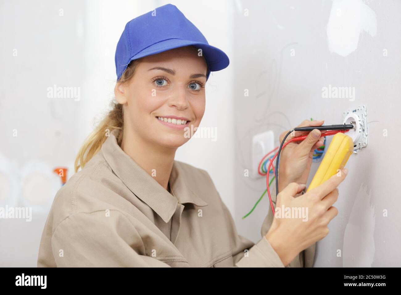 Female electrician fixing socket hi-res stock photography and images ...