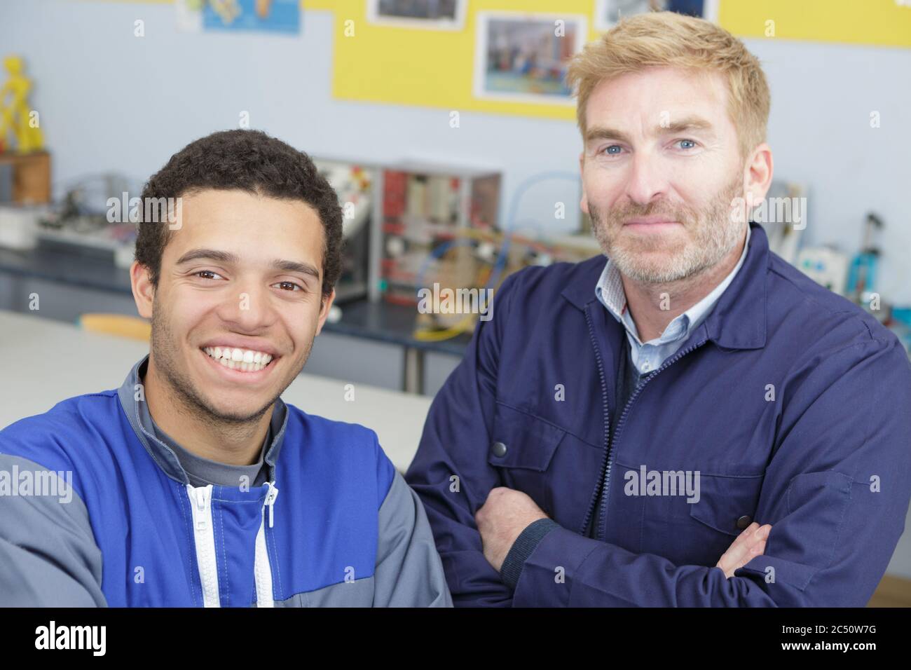 apprentice and mechanic looking at camera Stock Photo - Alamy