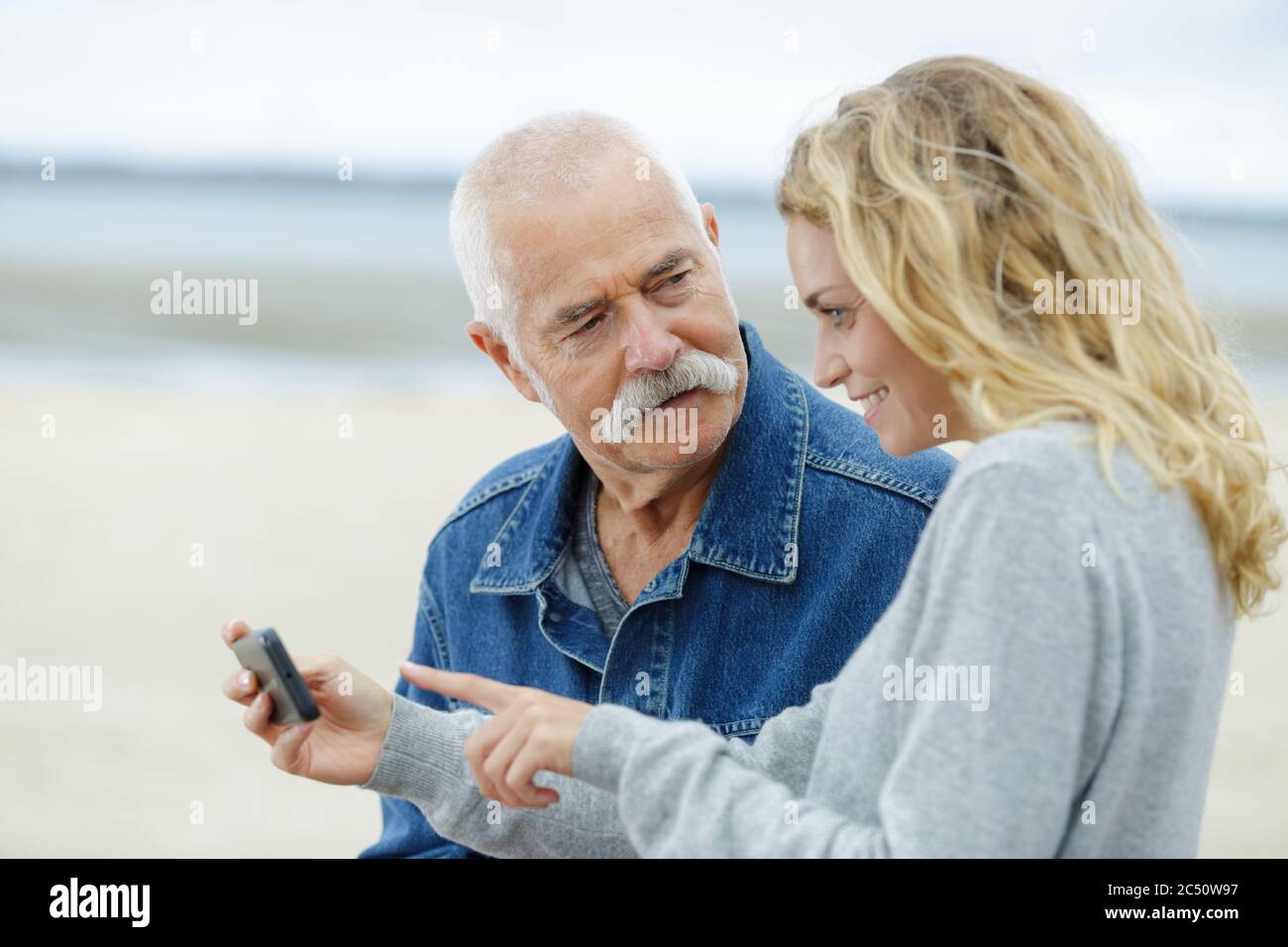father and daughter checking a phone Stock Photo - Alamy