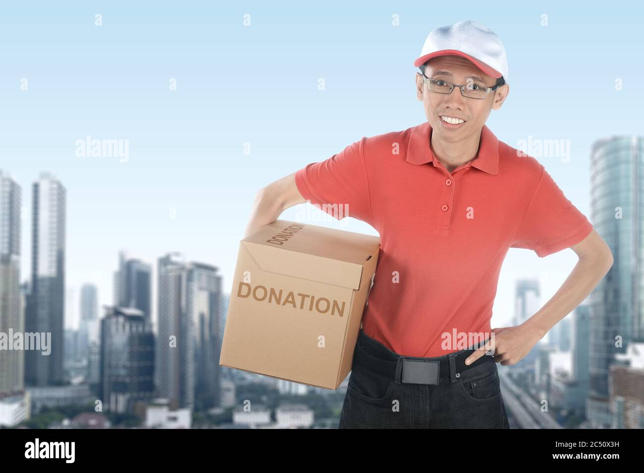 Asian man carrying box with donation text to collecting donations in ...