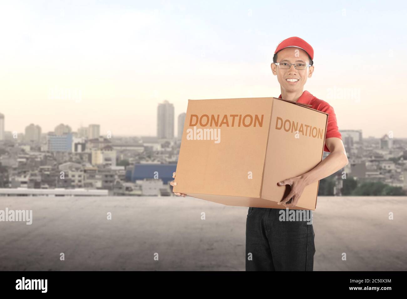 Asian man carrying box with donation text to collecting donations in ...