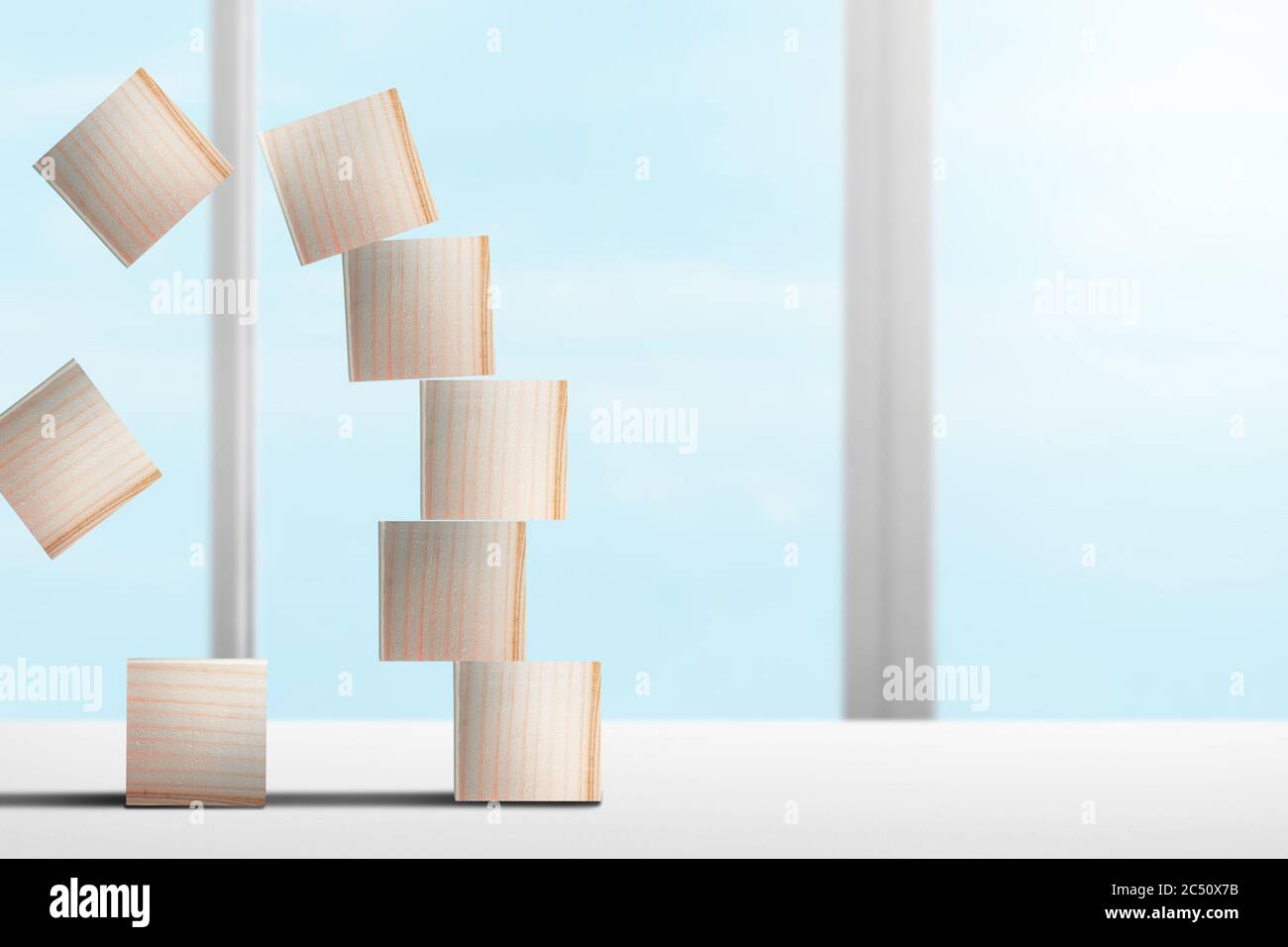 Falling stack wooden cube on the table Stock Photo - Alamy