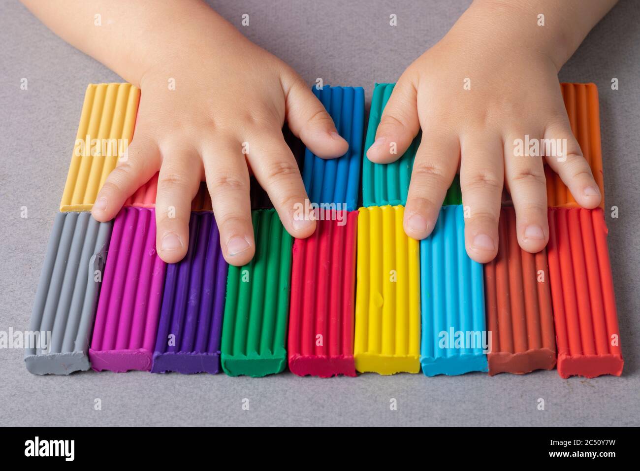 colorful clay with hands above, pre-schooler holding play dough Stock ...