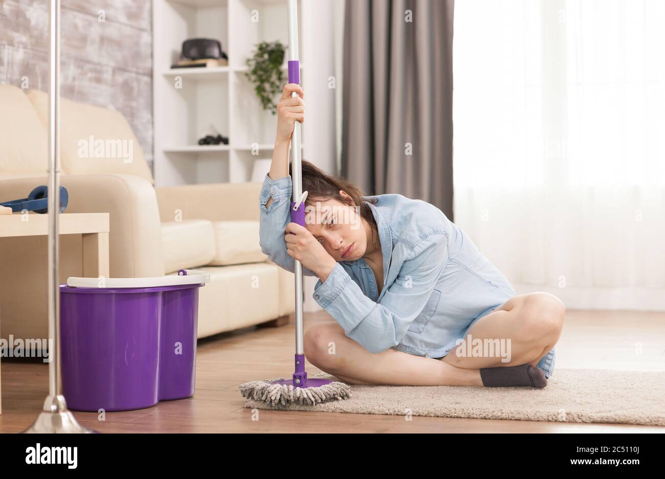 Tired woman after mopping the floor in apartment Stock Photo - Alamy