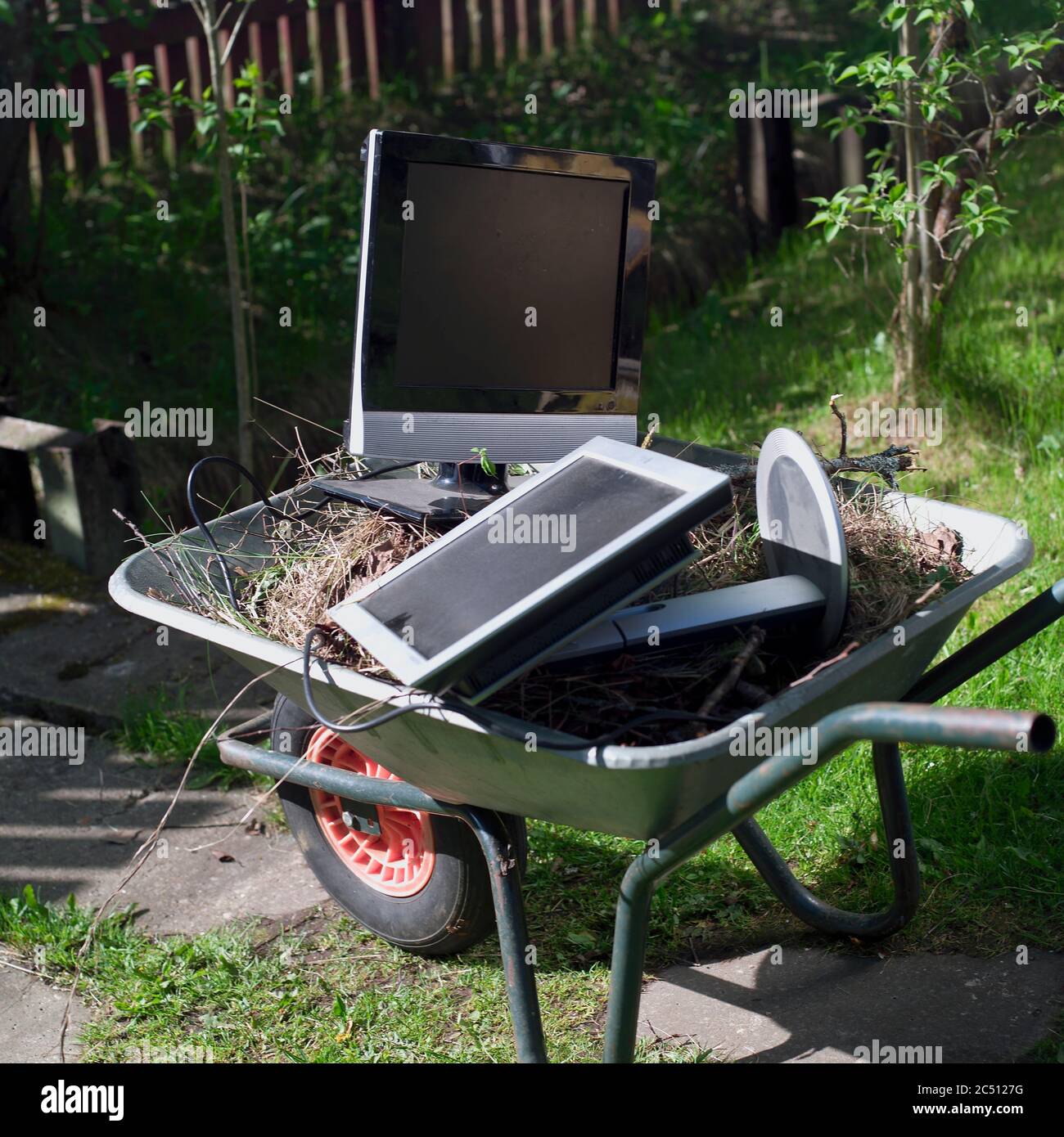 Old computers and monitors loaded into a trolley, outdoor shot Stock ...