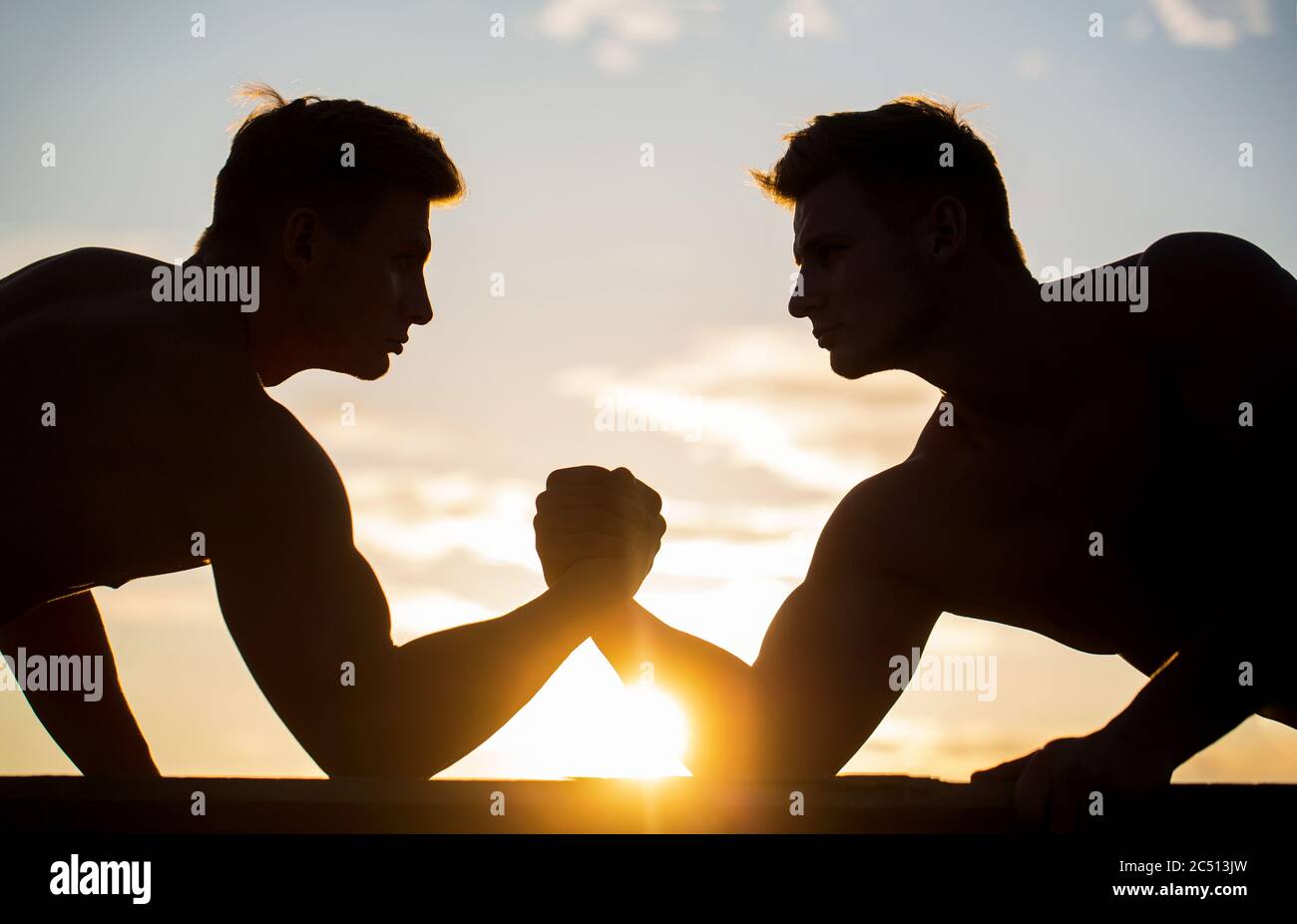 Silhouette of hands that compete in strength. Rivalry, closeup of male ...