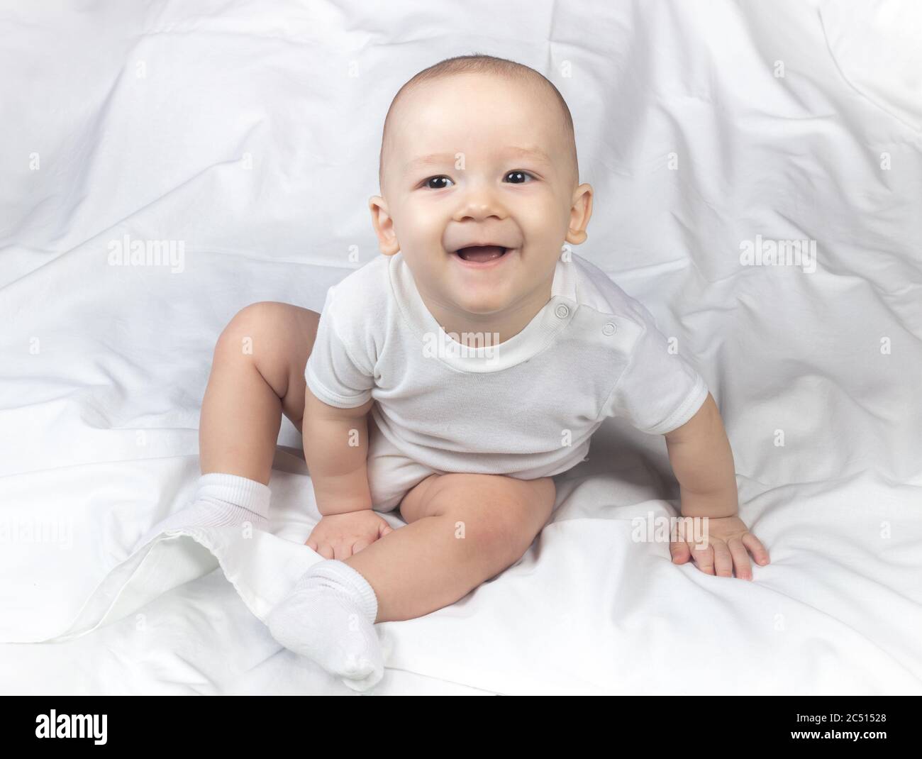 Photo of sitting smiling seven month old baby Stock Photo - Alamy