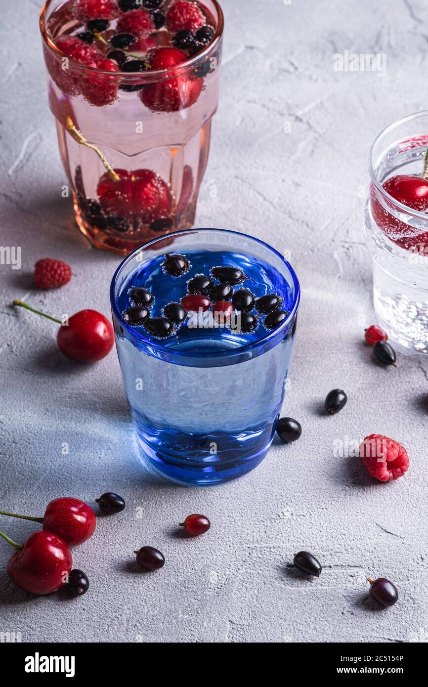 Fresh cold sparkling water drink with cherry, raspberry and currant ...