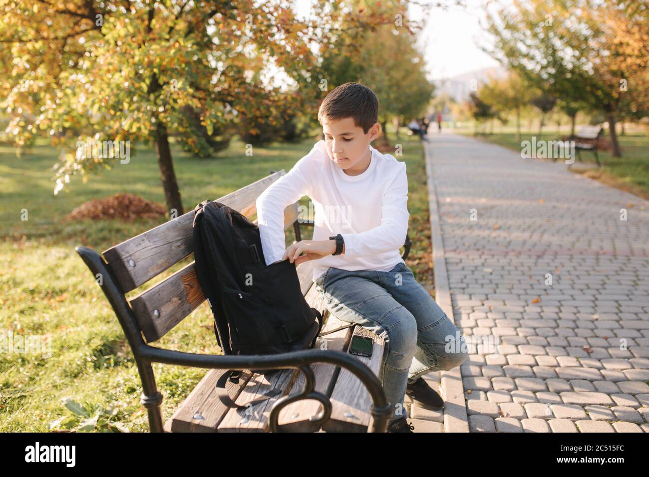 Handsome teenage boy take from his backpack powerbark for charging ...