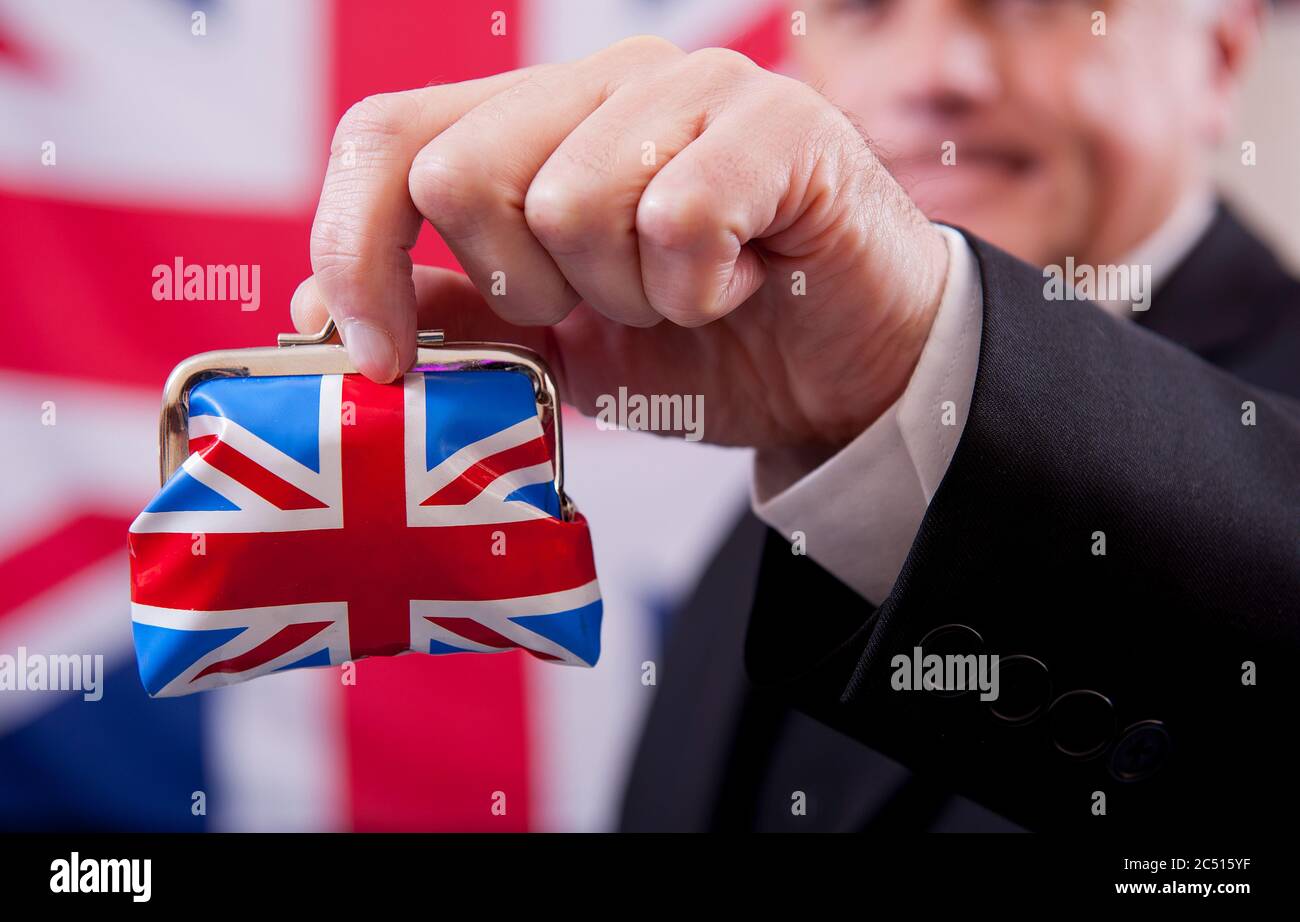 Businessman holding a Union Jack purse towards the camera. A Union Jack ...
