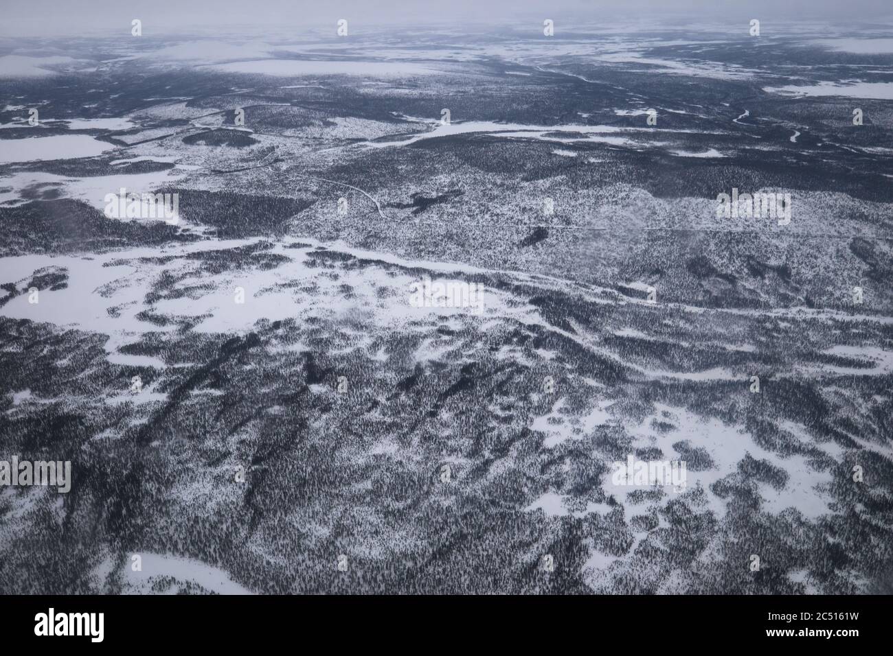 Aerial shot of the Kiruna area with a road in Lapland in Sweden in ...