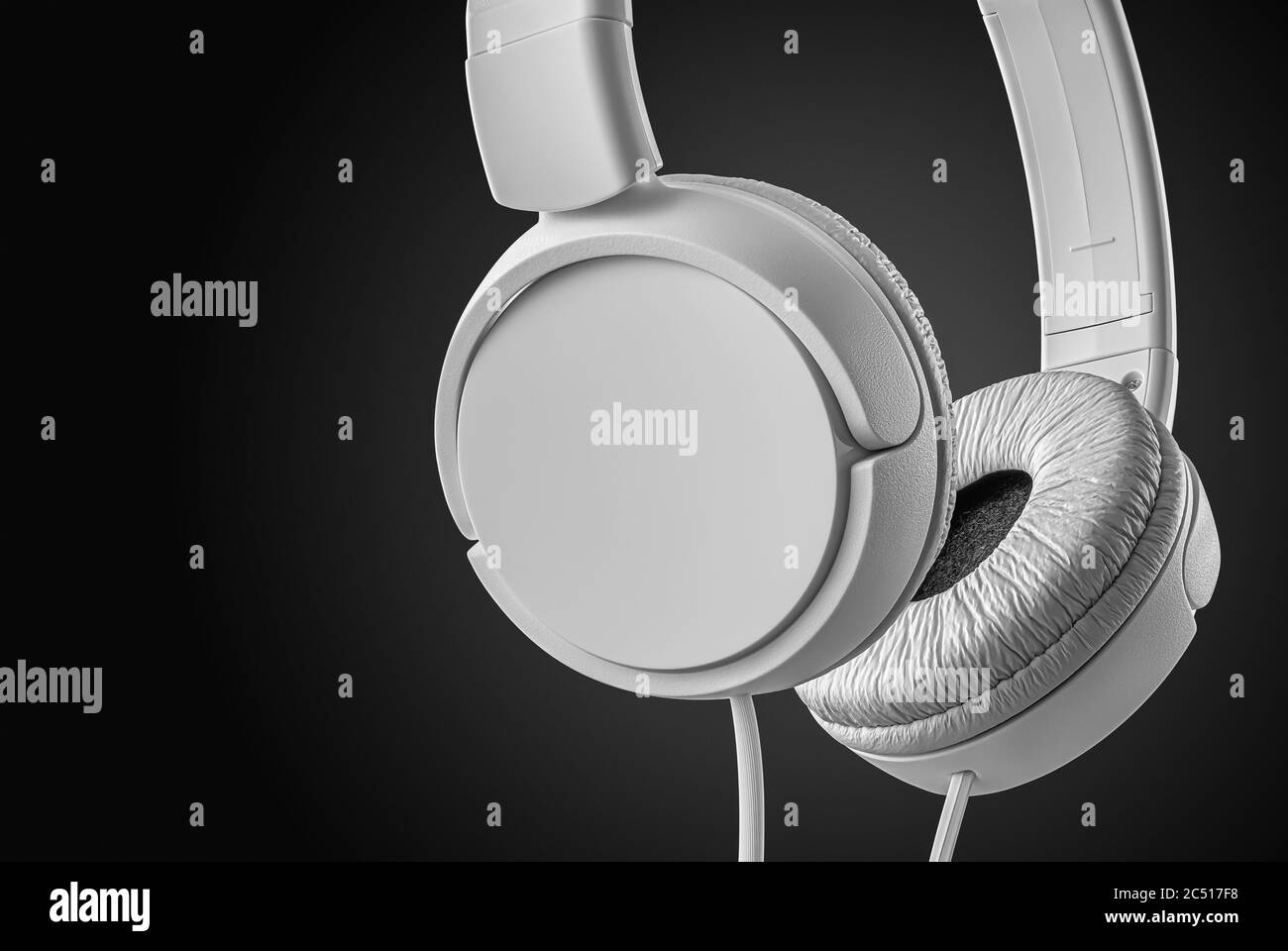 Close up bottom view of a part of white modern headphones saved with ...